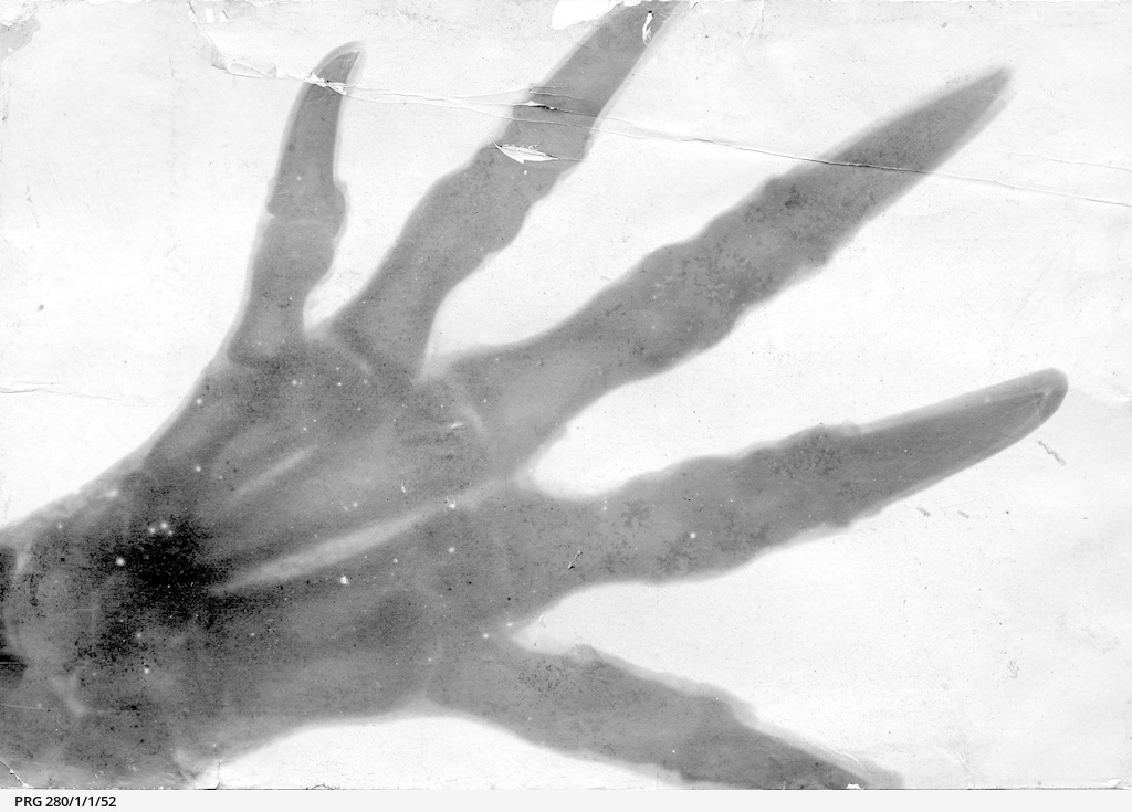 A silhouette of a hand with the fingers splayed apart • Photograph ...