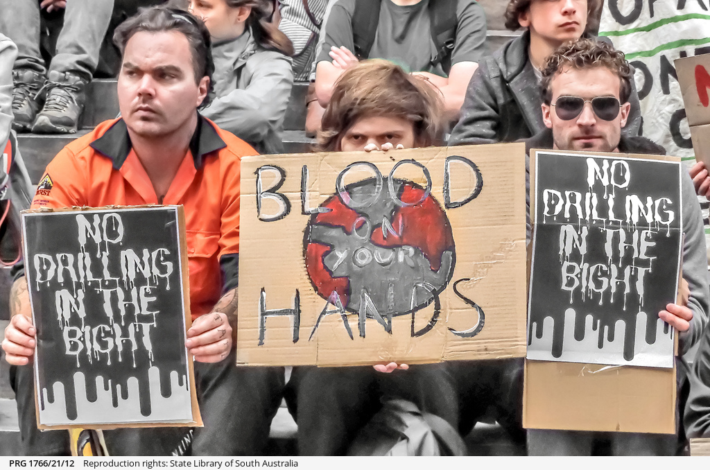 protesters holding signs at the This is Climate Change Solidarity Sit ...