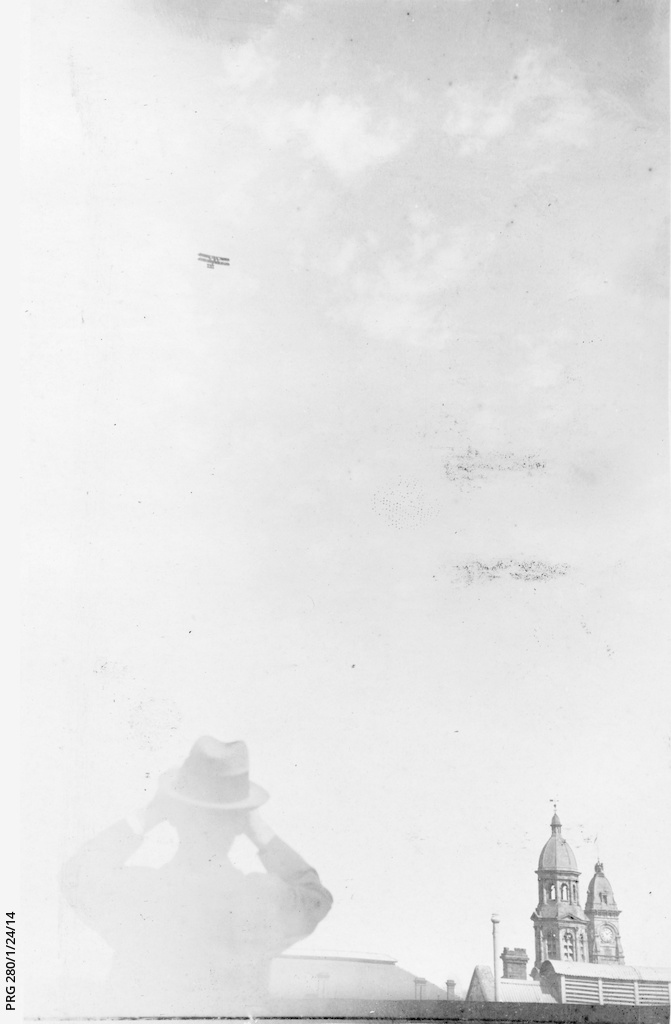 Sir Henry Galway observing a bi-plane flying over Adelaide • Photograph ...