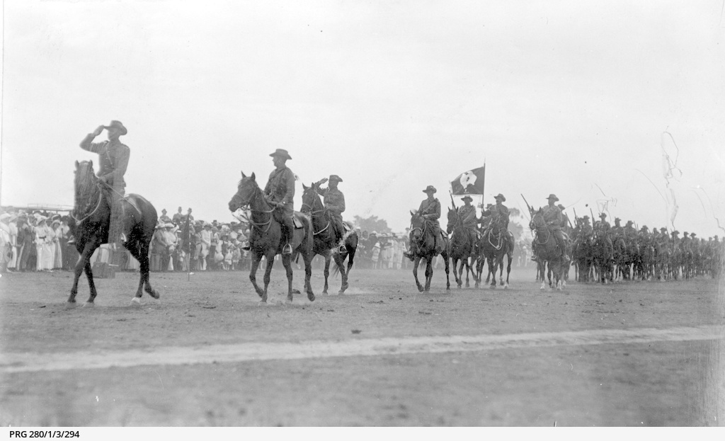 A parade of mounted military marching past a large crowd near Adelaide ...